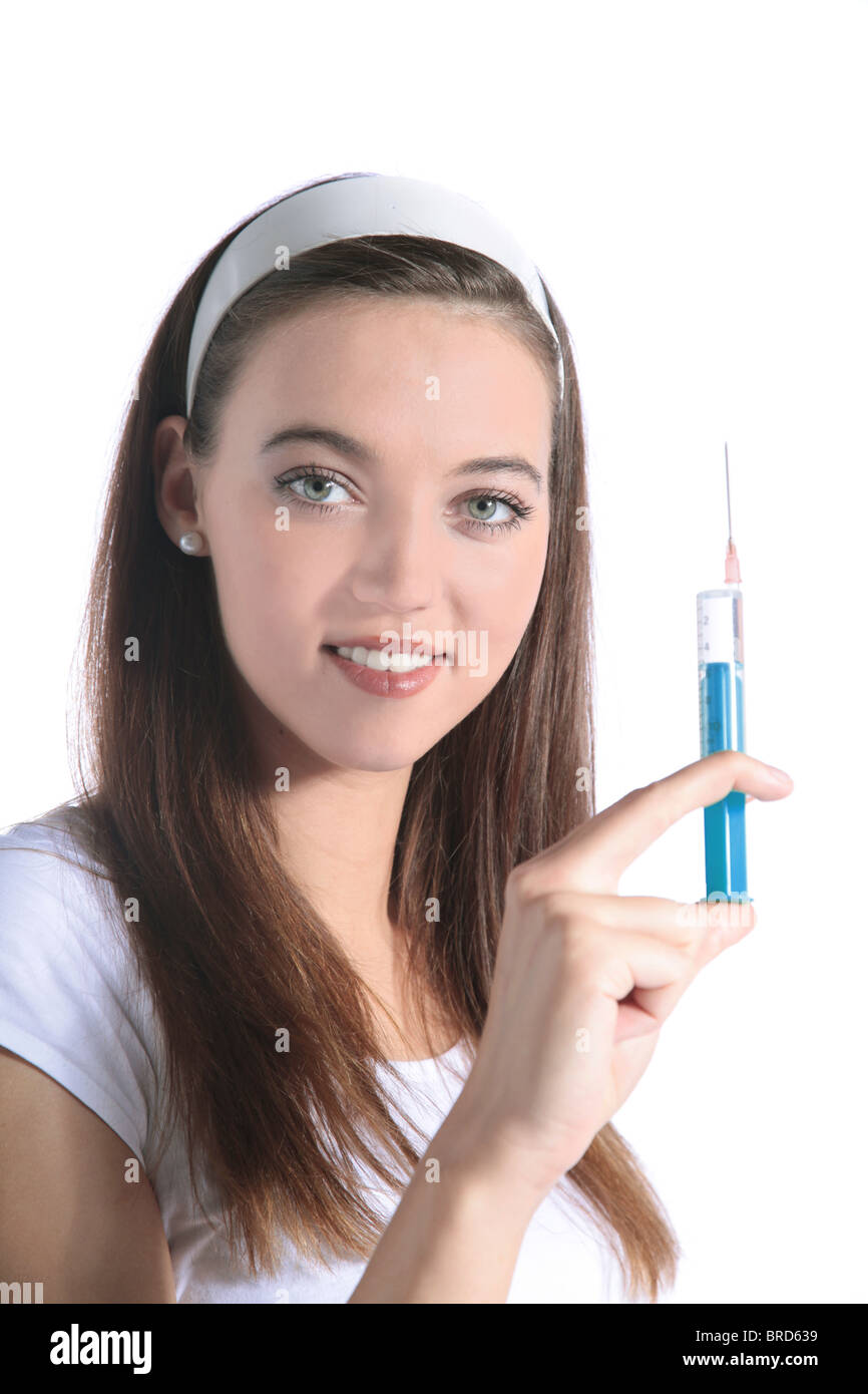 An attractive young woman holding a syringe. All isolated on white ...