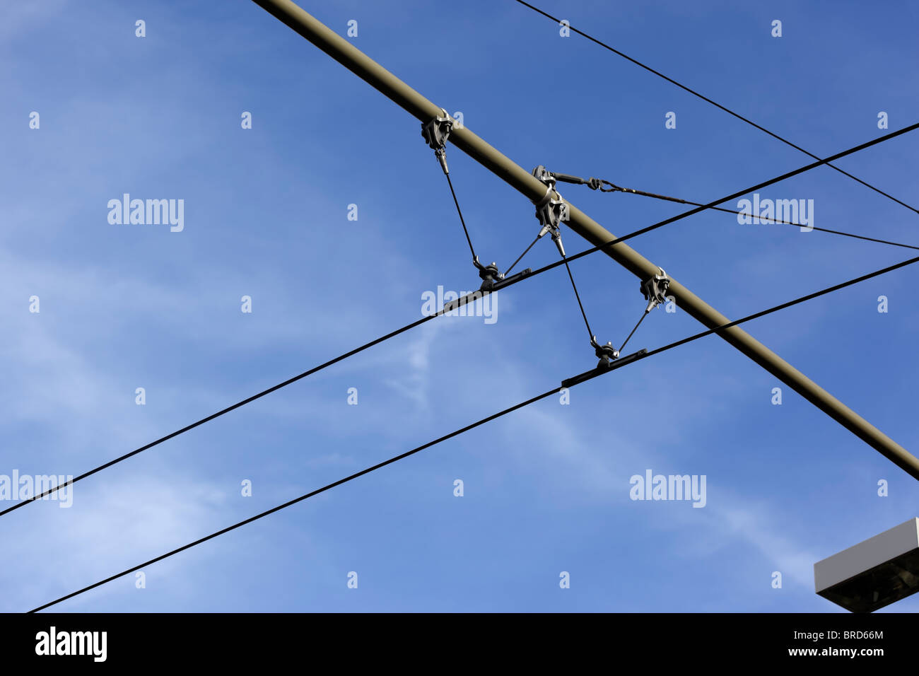 Overhead electric bus power lines on blue sky Stock Photo - Alamy