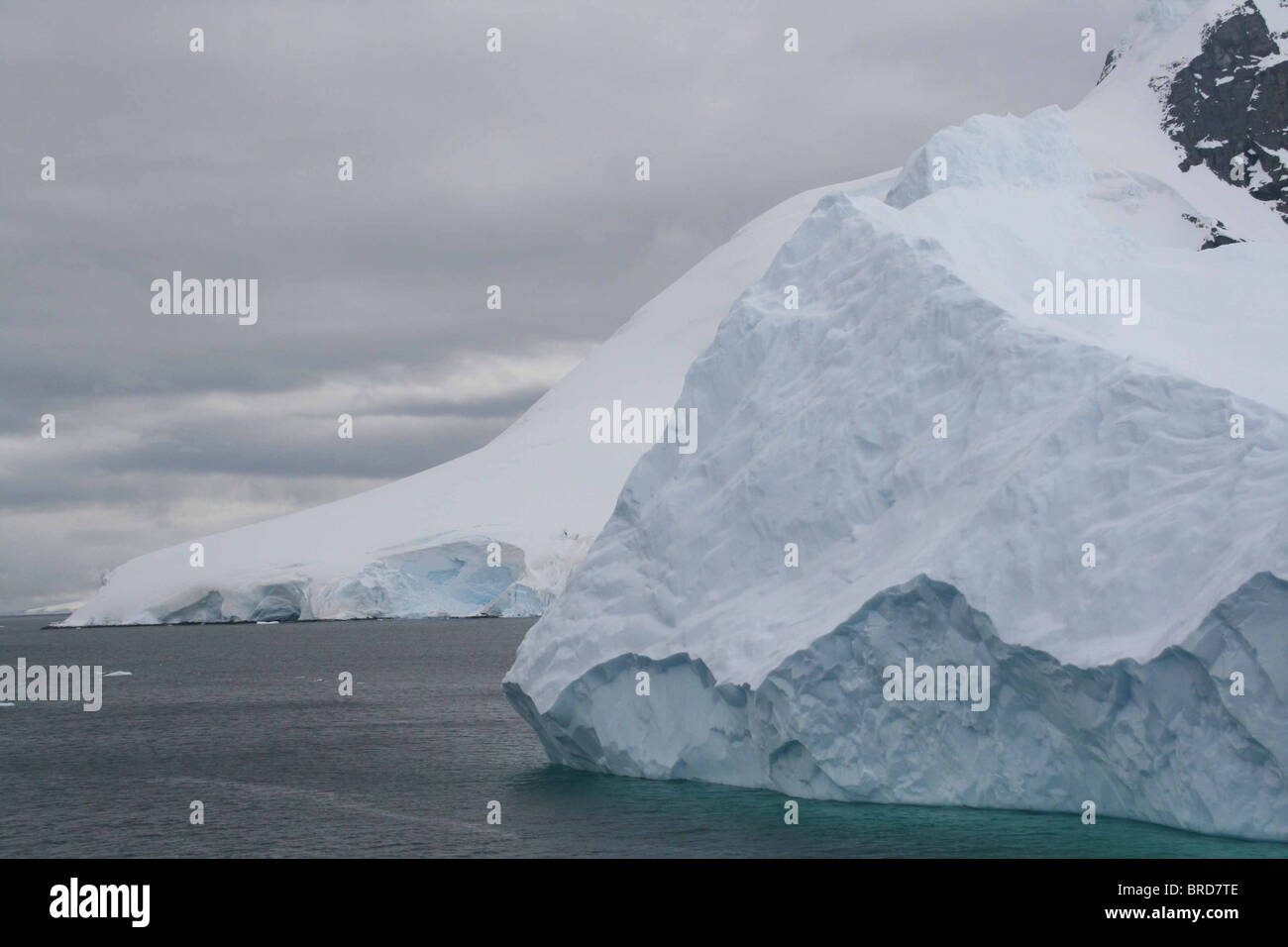 Iceberg floating offshore, overcast day, Neko Harbor, Andvord Bay ...