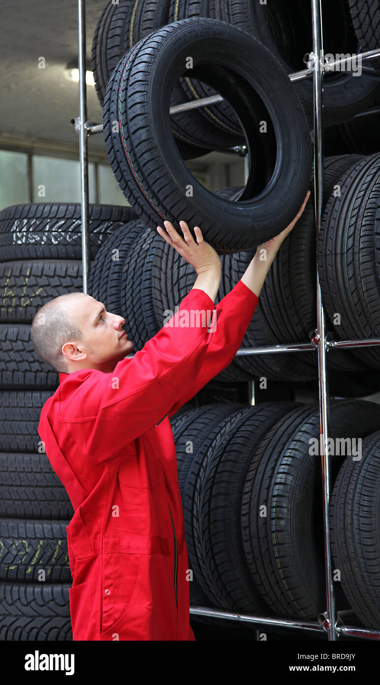 A mechanist working hard in a tire workshop Stock Photo - Alamy