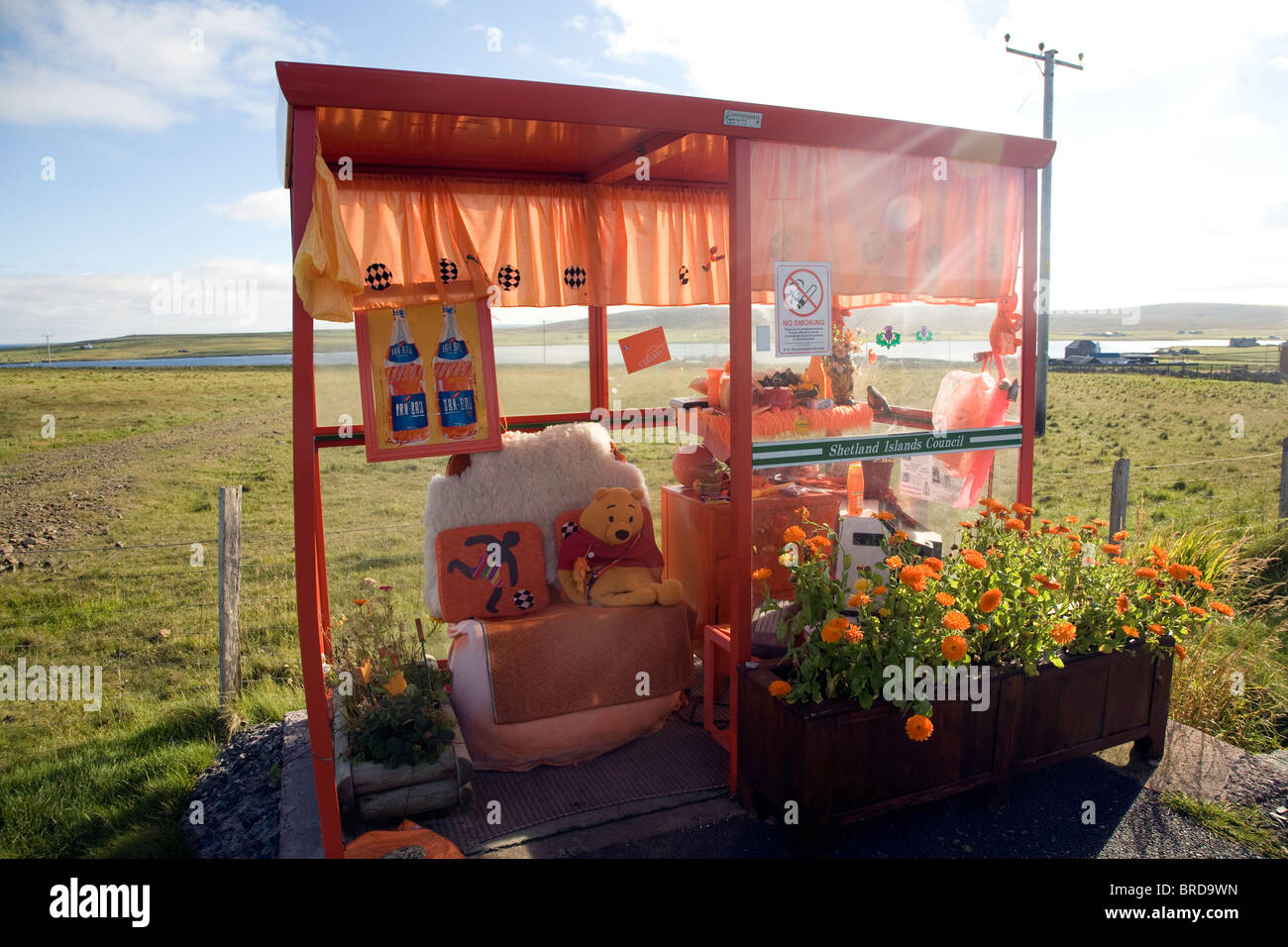 Orange colour theme decorated bus shelter, Unst, Shetland Islands ...