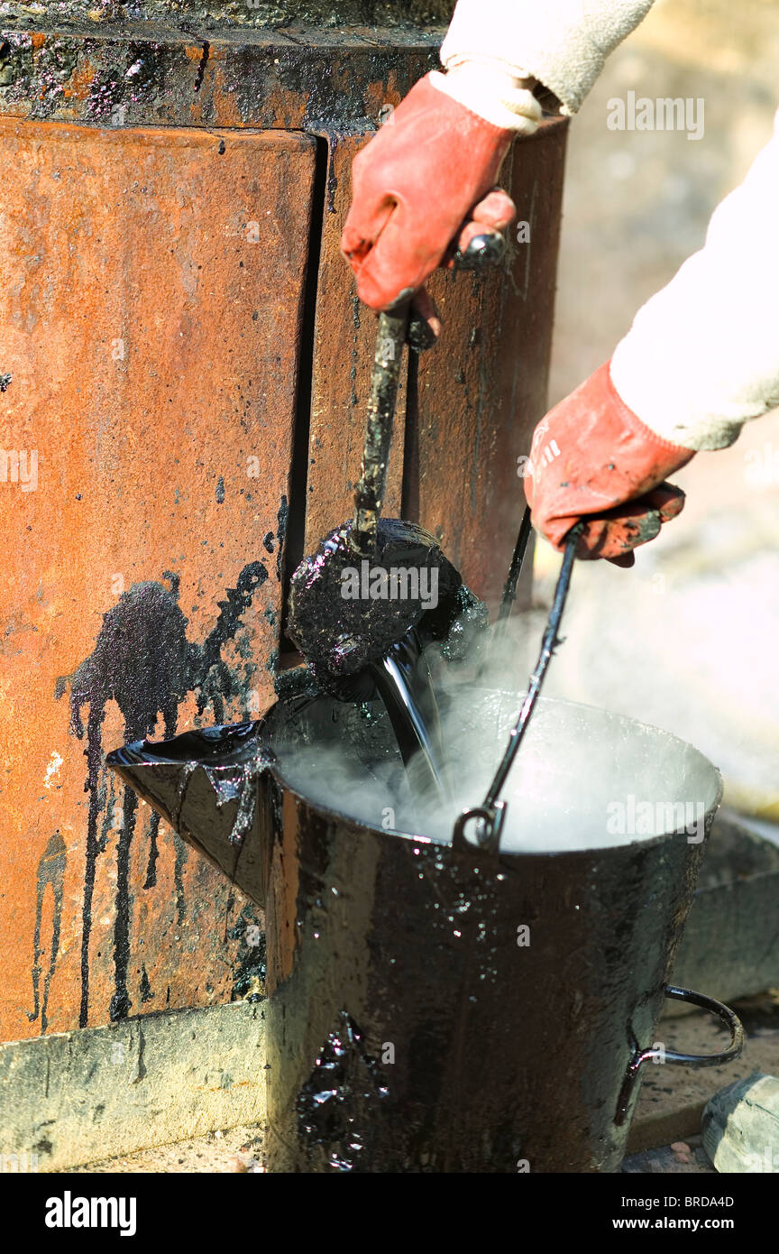 Bucket of molten tar Stock Photo - Alamy