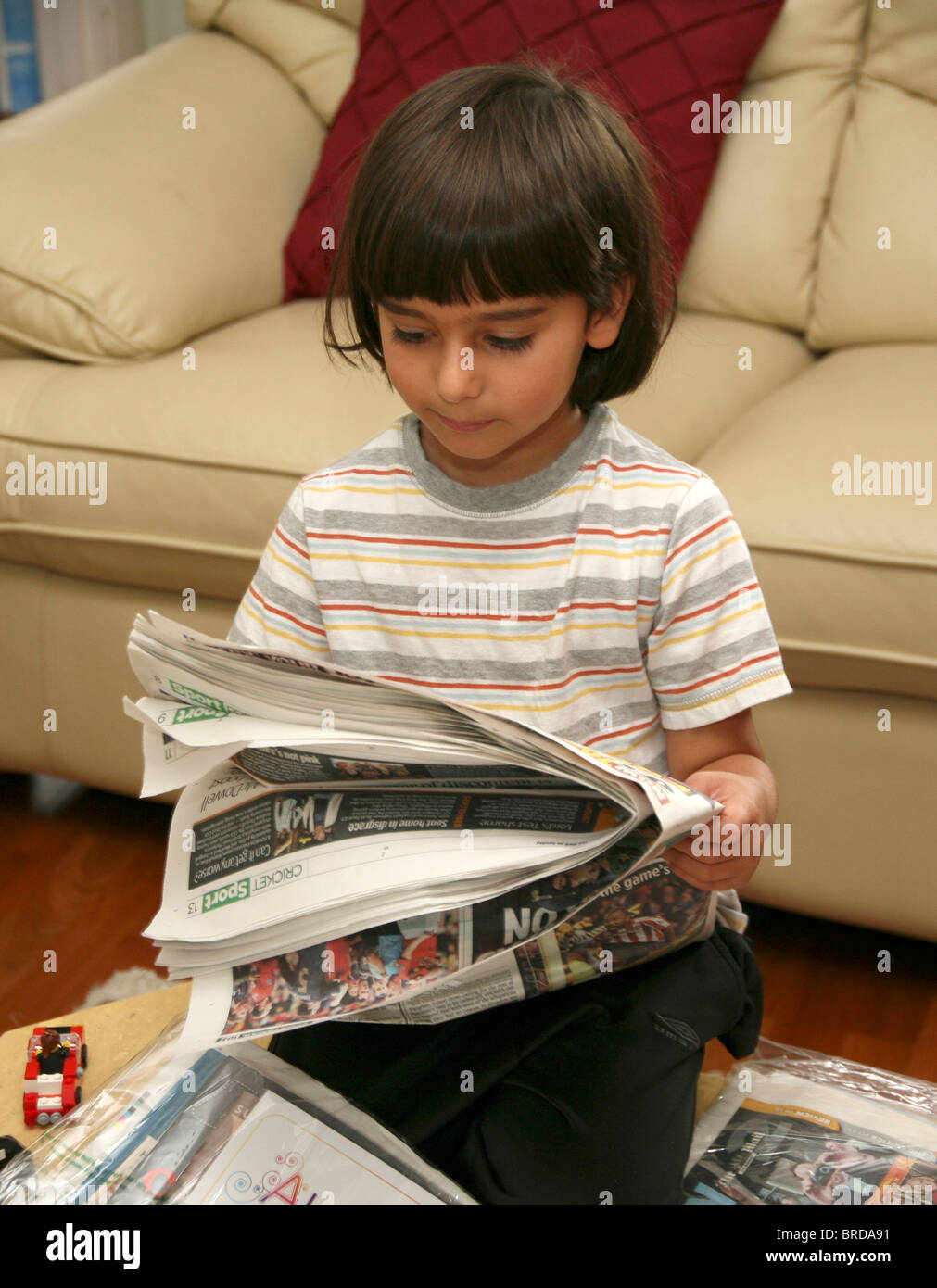 Boy reading newspaper hi-res stock photography and images - Alamy