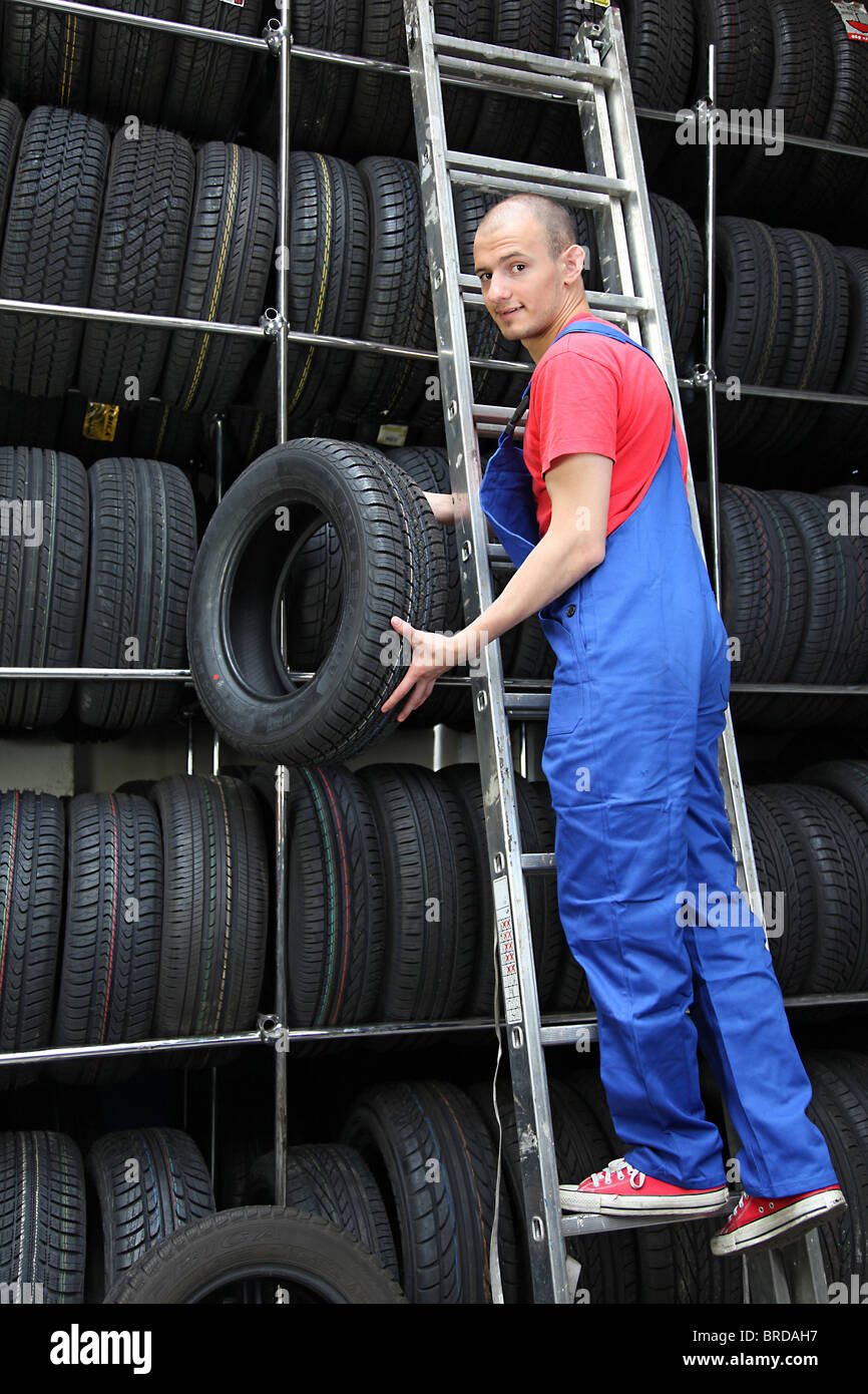 A motivated worker in a tire workshop restocking the goods Stock Photo ...