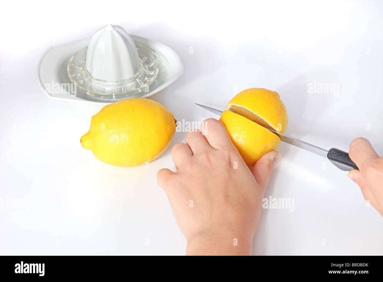 A person cutting lemons. All isolated on white background Stock Photo ...