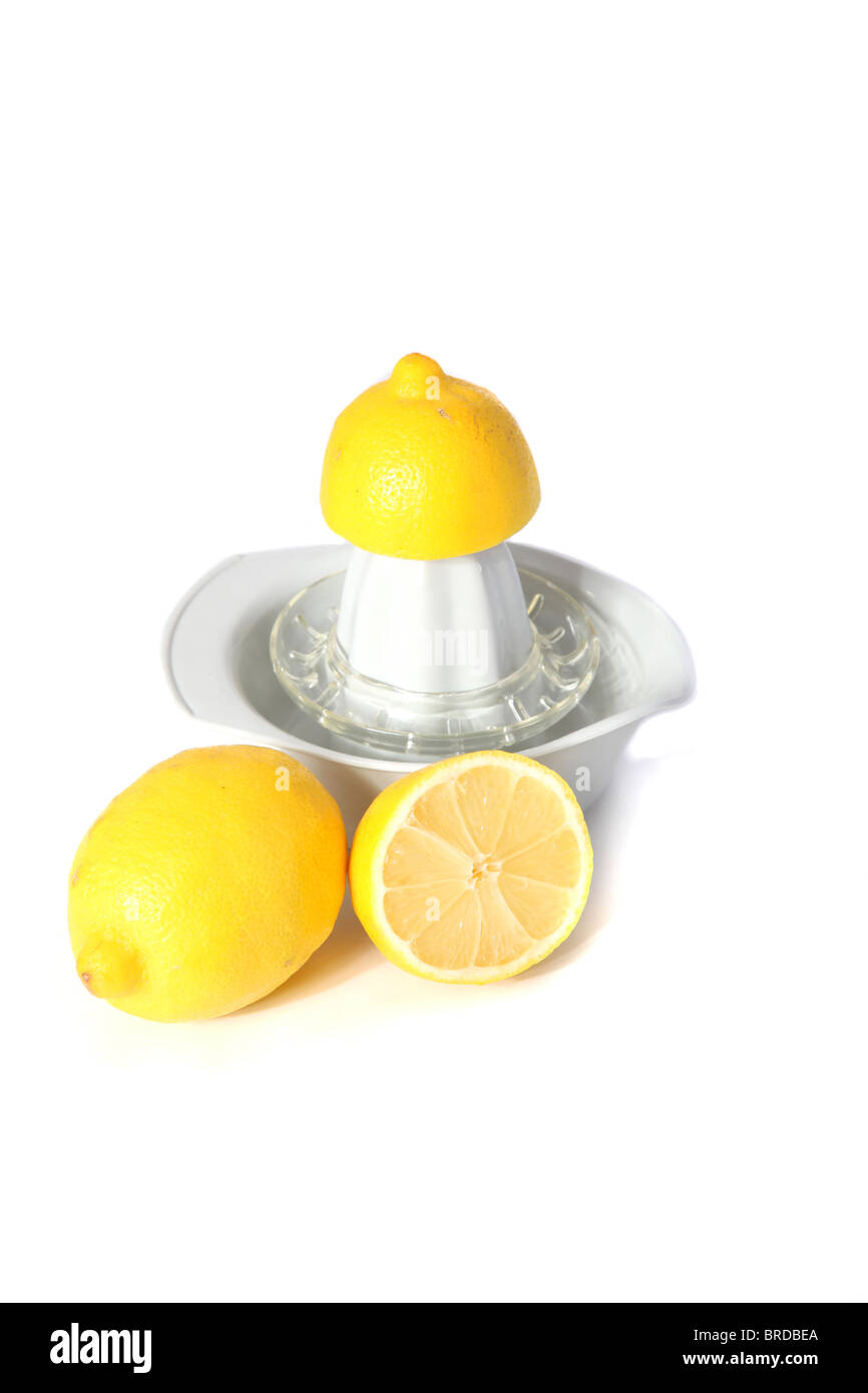 A lemon squeezer and lemons. All isolated on white background Stock ...
