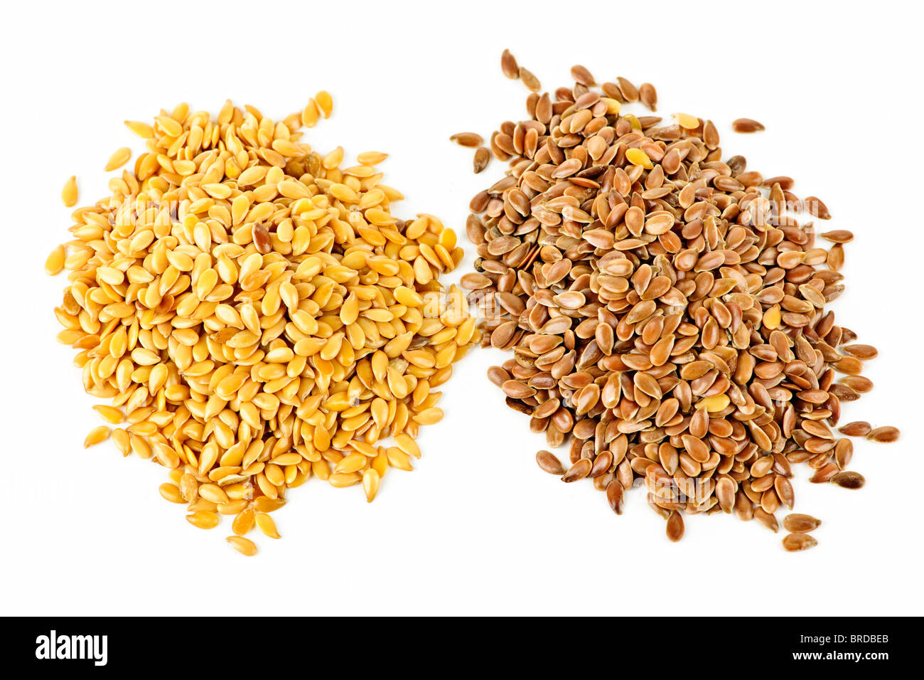 Heaps of brown and golden flax seed or linseed isolated on white background Stock Photo - Alamy