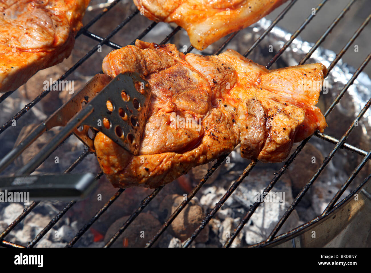 A nice grill barbecue with delicious marinaded steaks Stock Photo - Alamy