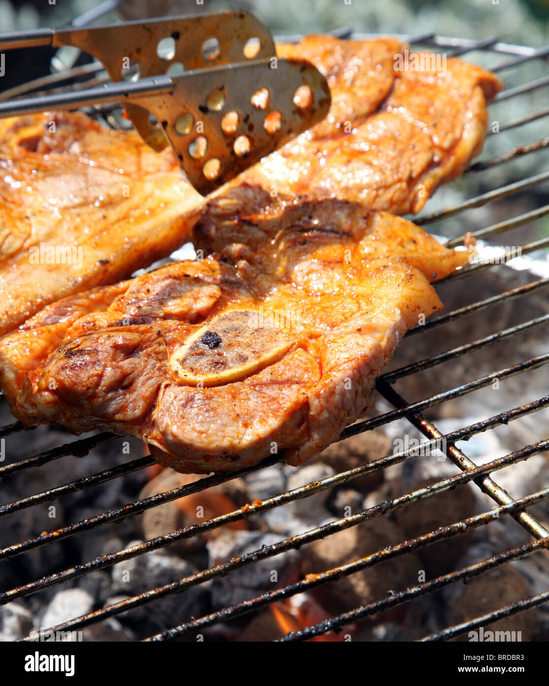 A nice grill barbecue with delicious marinaded steaks Stock Photo - Alamy