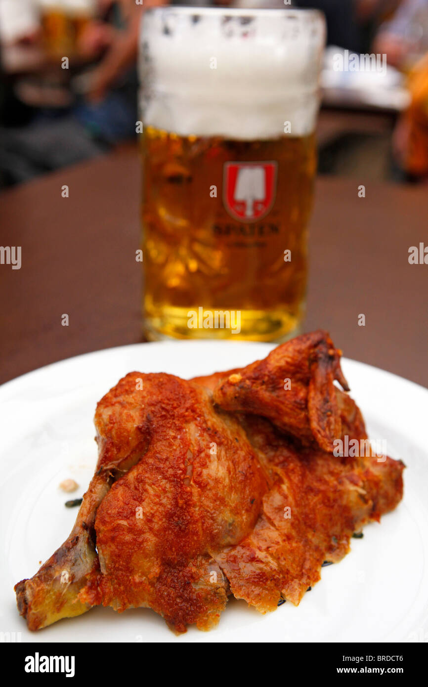 A Hendl (half of a grilled chicken) is served with a liter Mass of beer ...