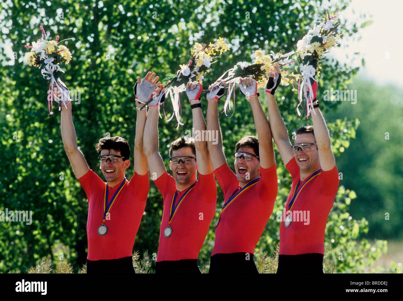 Mens cycling team on the podium with their gold medals Stock Photo - Alamy