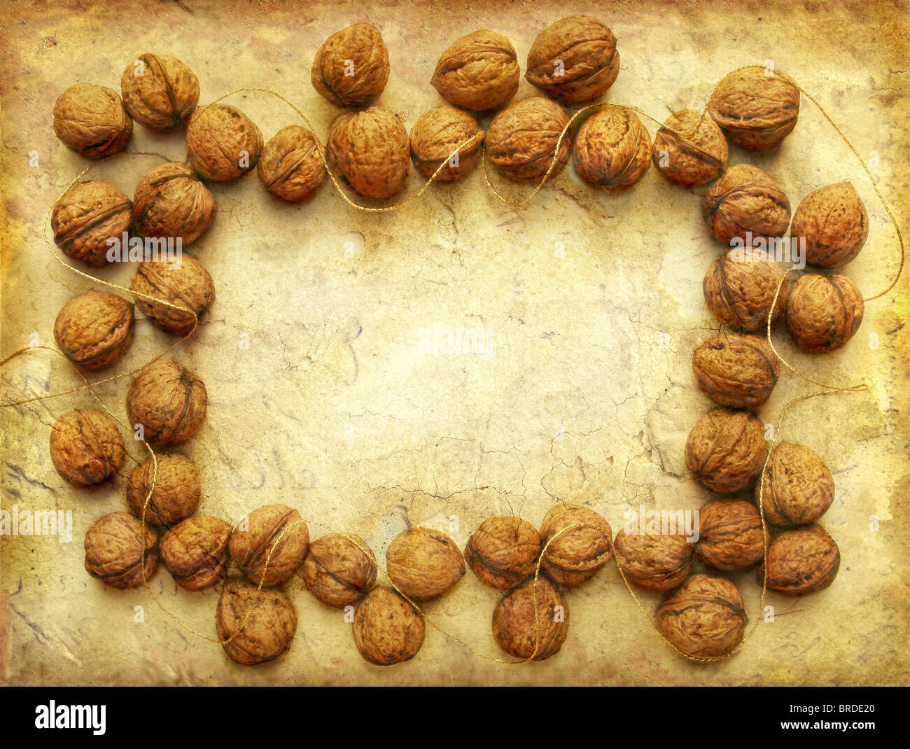 Walnut frame with golden string in grunge style Stock Photo - Alamy