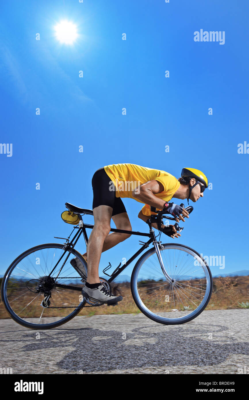 A biker riding a bike on an open road Stock Photo - Alamy