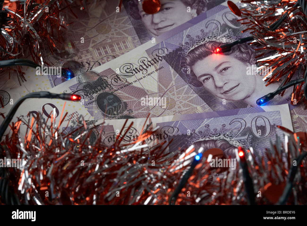 pile of twenty pounds sterling banknotes with christmas tinsel ...