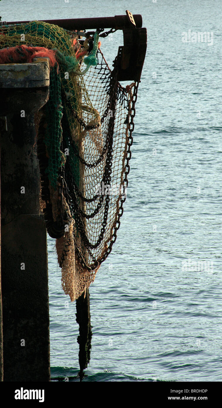 A fishing net hanging over the side of the quay in Kingswear, Devon ...
