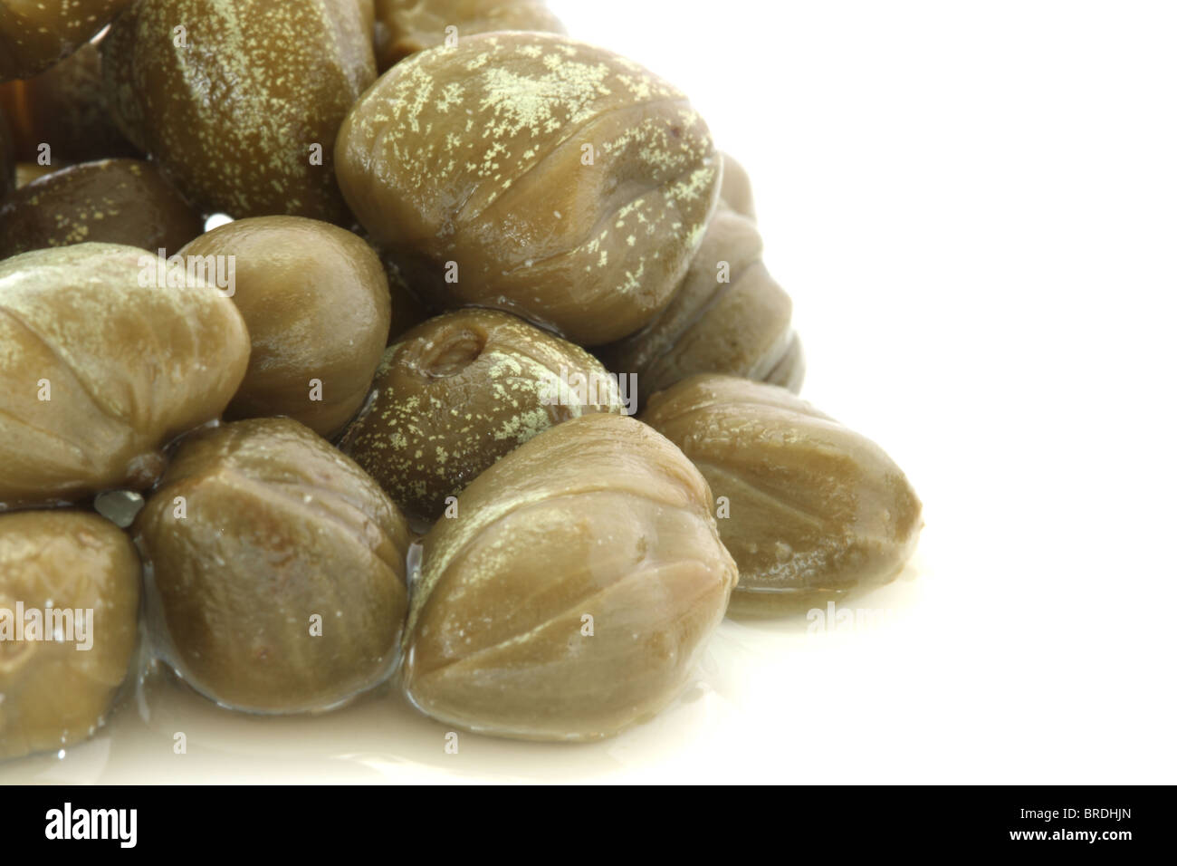 Pickled cappers on white background Stock Photo - Alamy