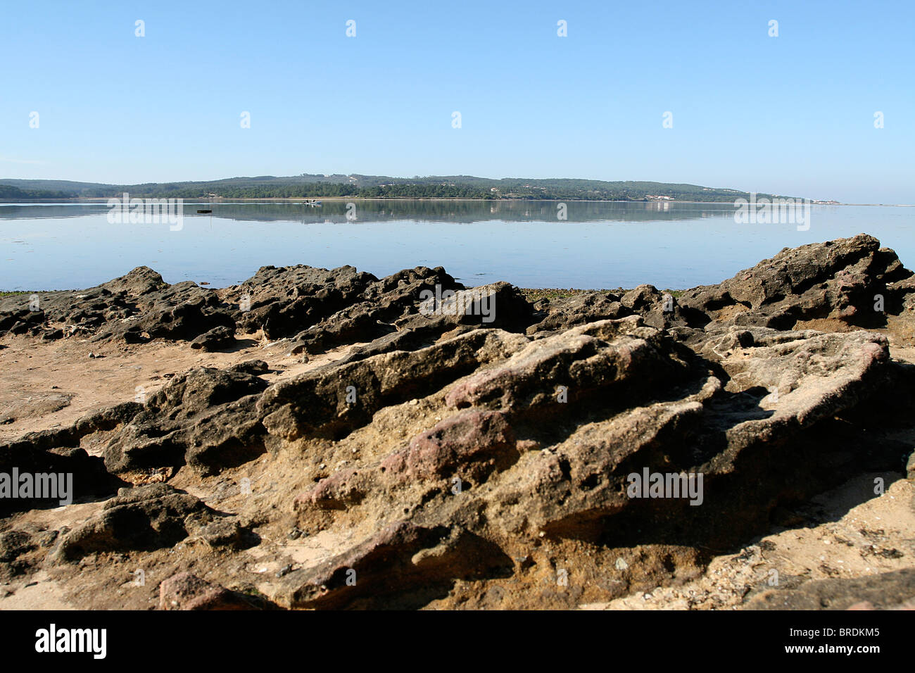 Rocks, lagoon and blue sky Stock Photo - Alamy