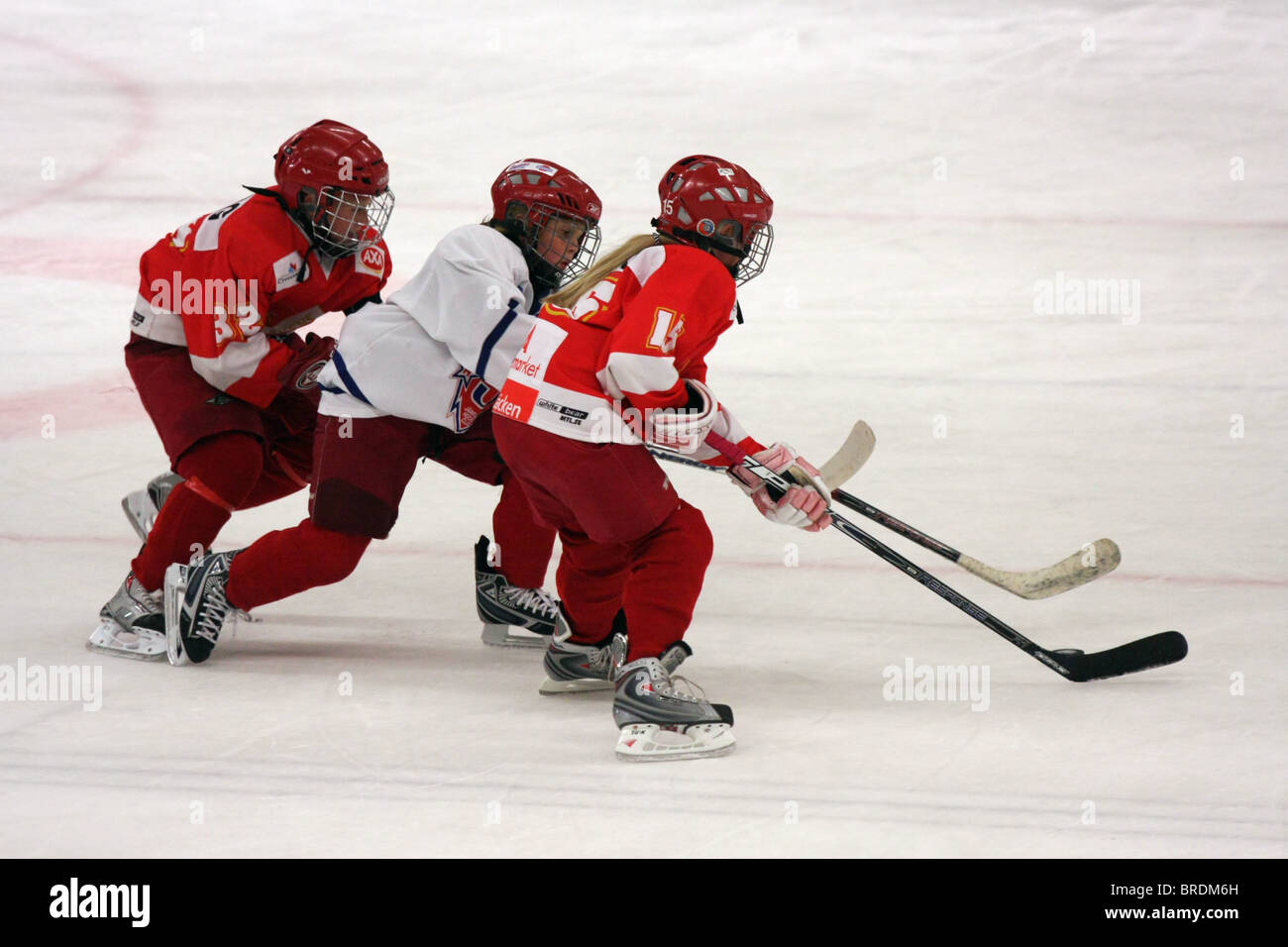 10-year old children playing ice-hockey in Sweden. The player to the ...
