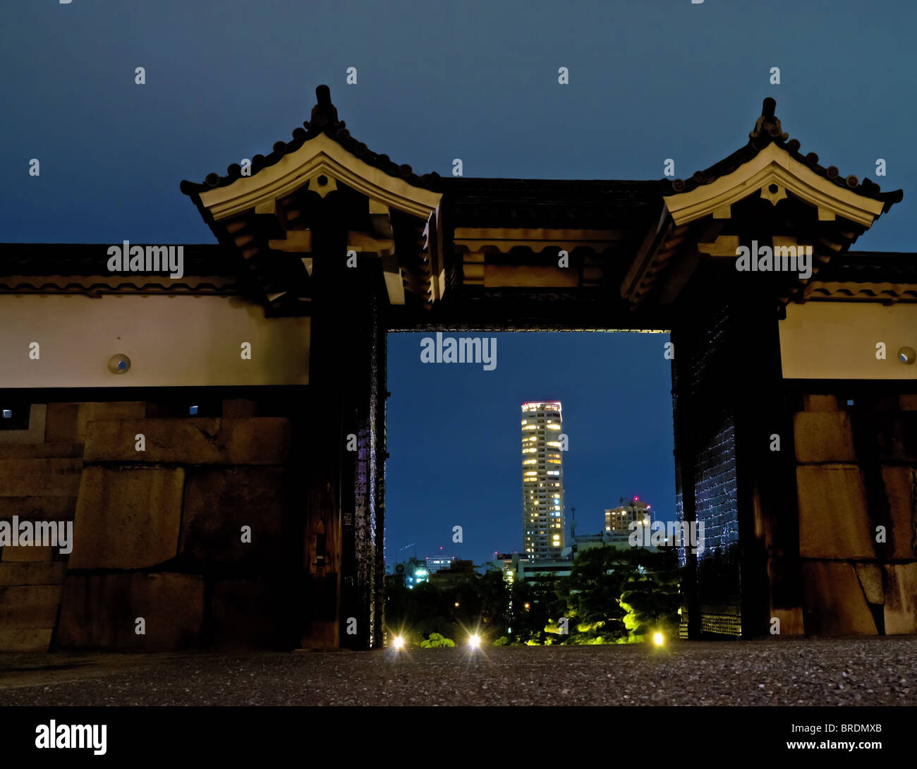 A view out from the main entrance of old Osaka castle into a night time ...