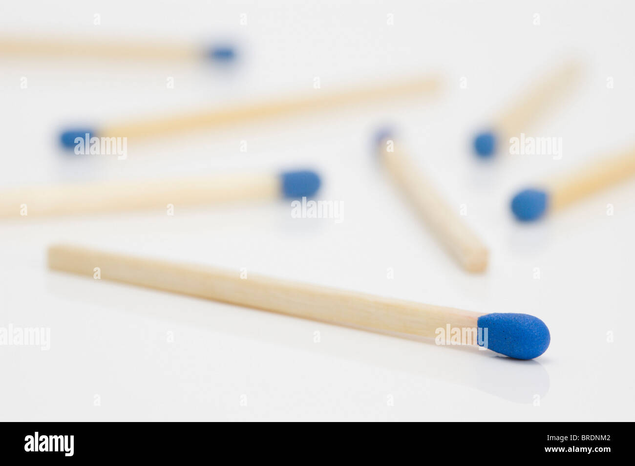 7 blue-tipped safety matches arranged on white Stock Photo - Alamy