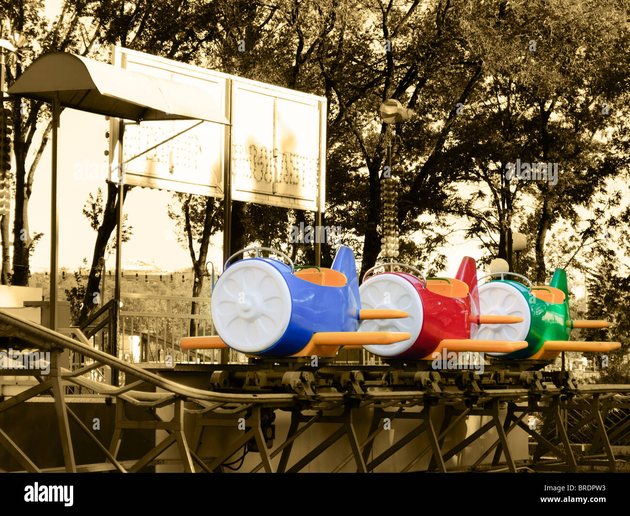 Planes carousel in amusement park. Colored planes on sepia background ...