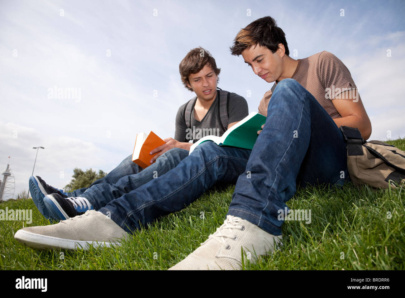 two young student reading books at the school park Stock Photo - Alamy