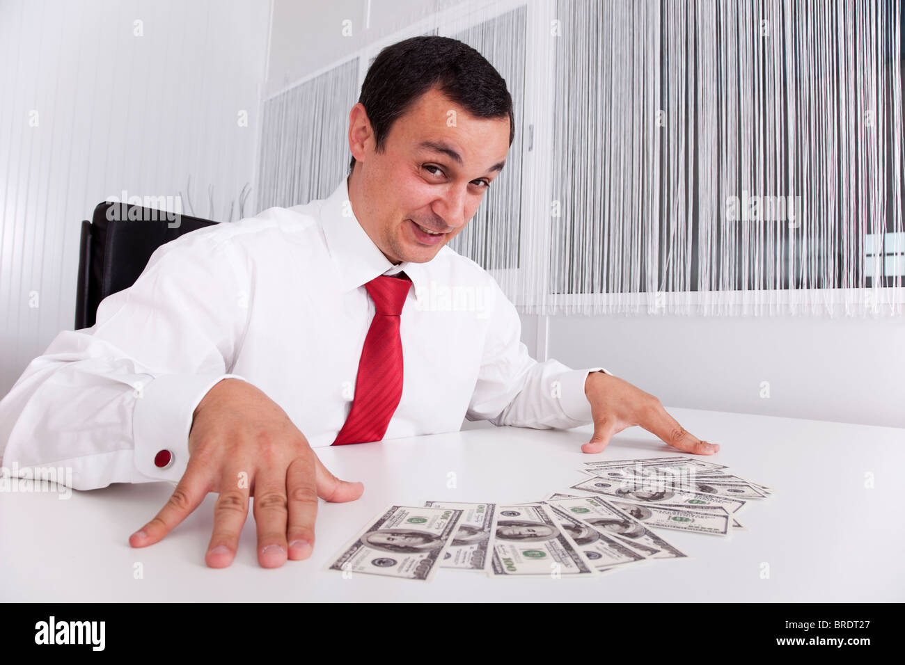 Businessman at the office enjoying his money Stock Photo - Alamy