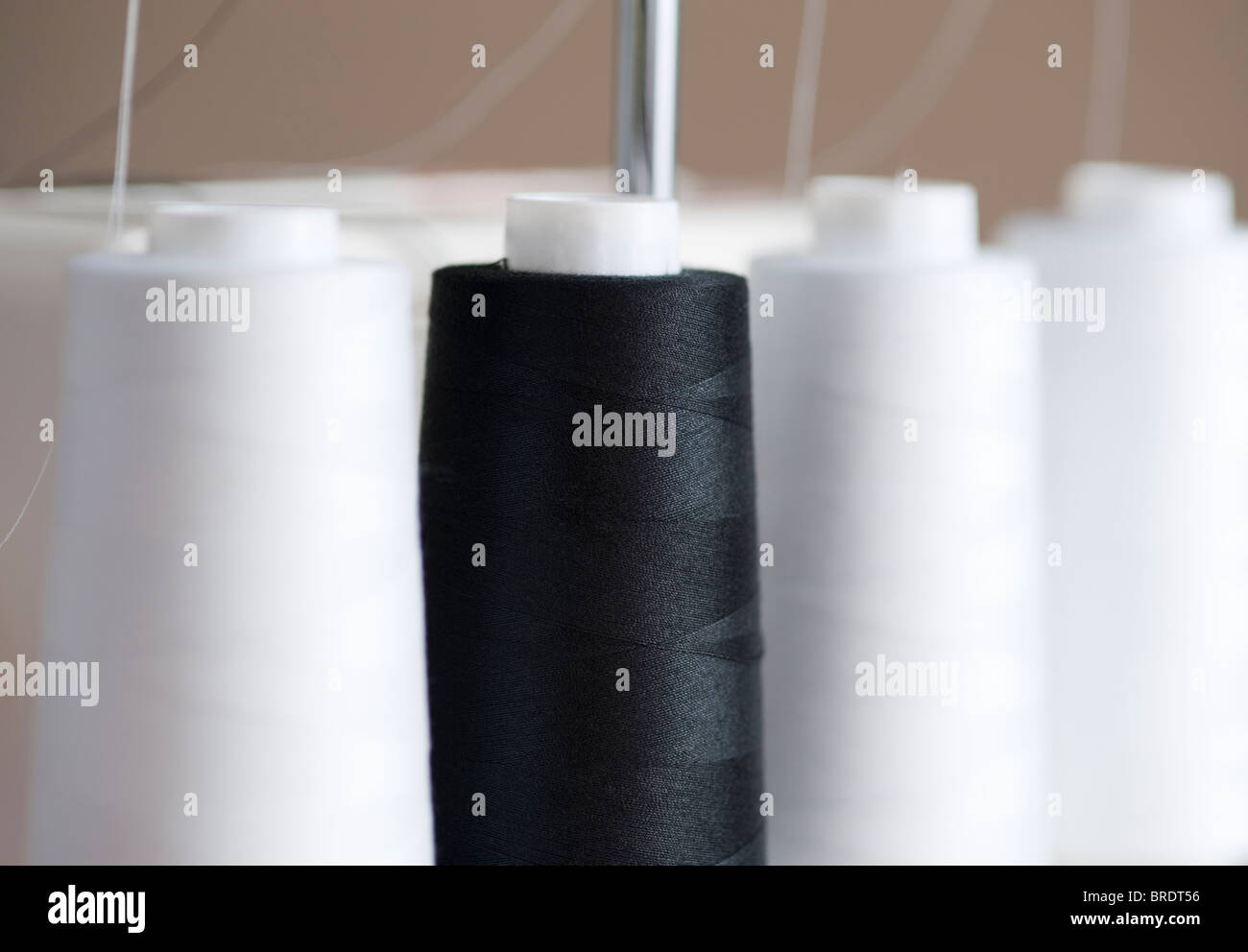 Black and white spools of thread on a serger sewing machine Stock Photo ...
