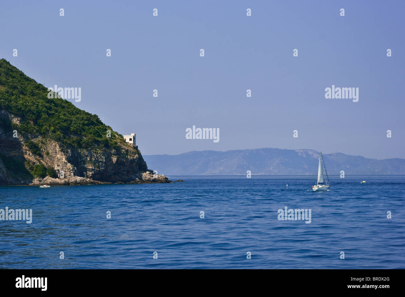sea sight view, with lighthouse and a sailing boat Stock Photo - Alamy