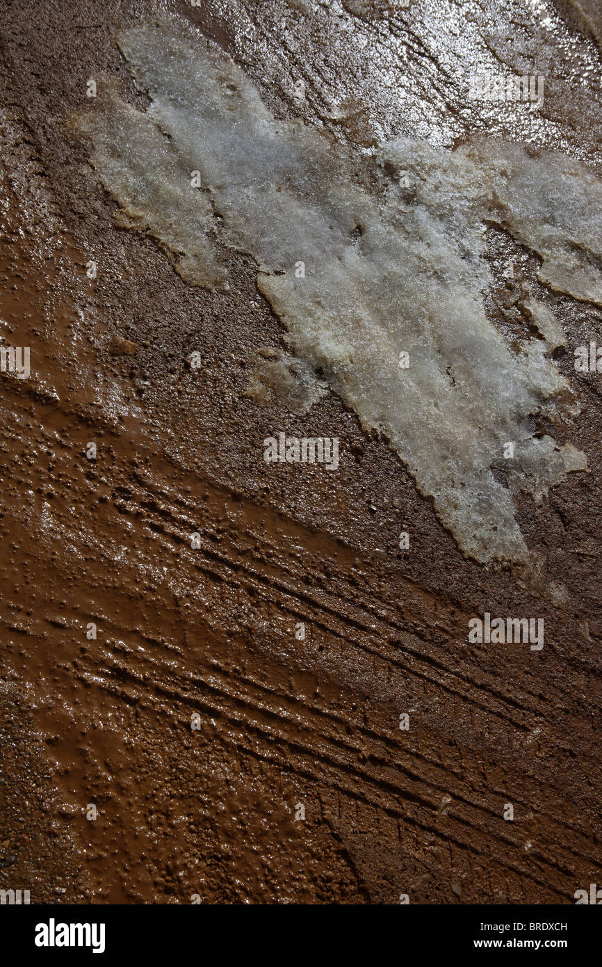 ice on mud red clay soil road with tires lines Stock Photo - Alamy