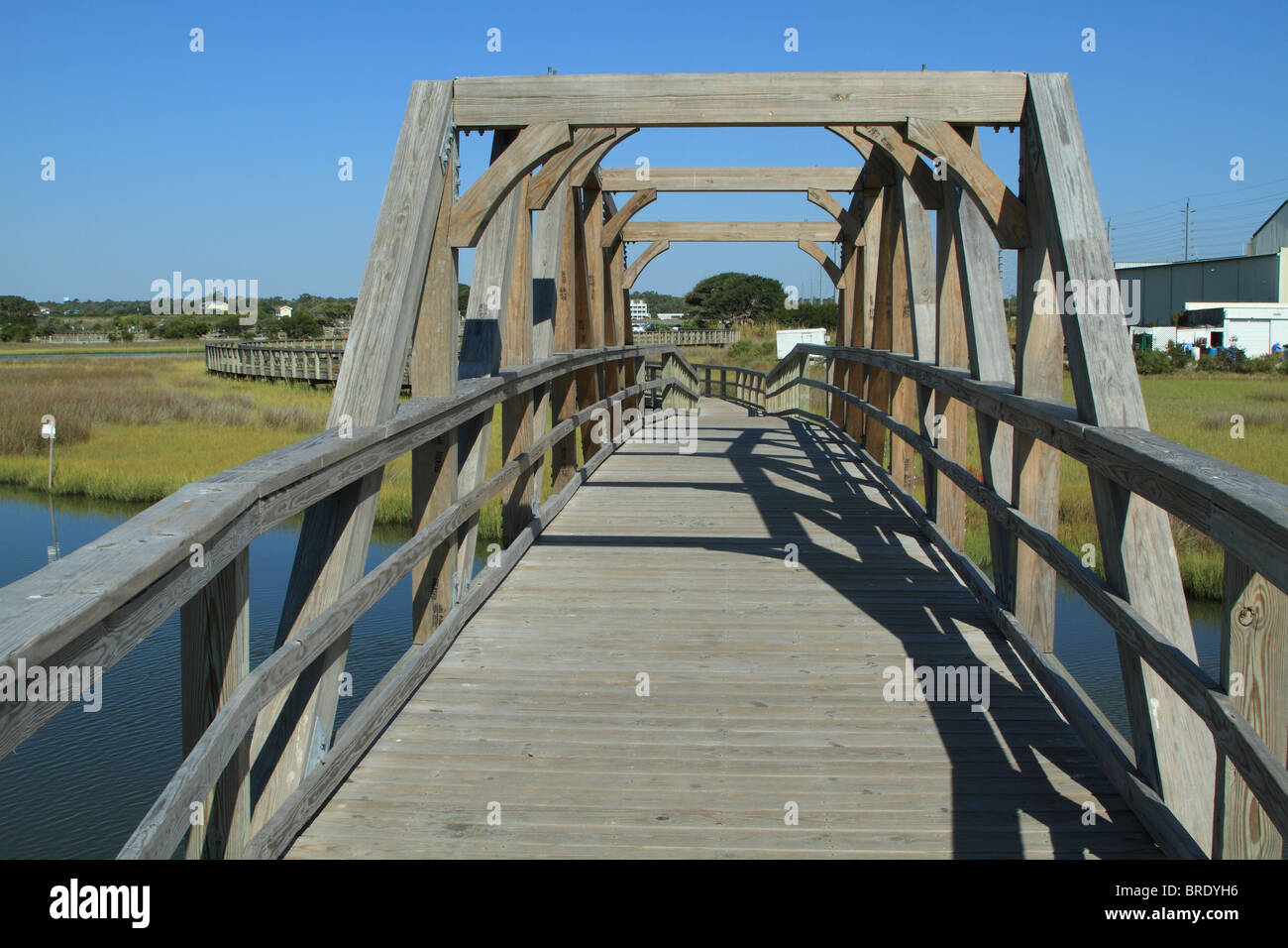 Wooden bridge across a marsh Stock Photo - Alamy