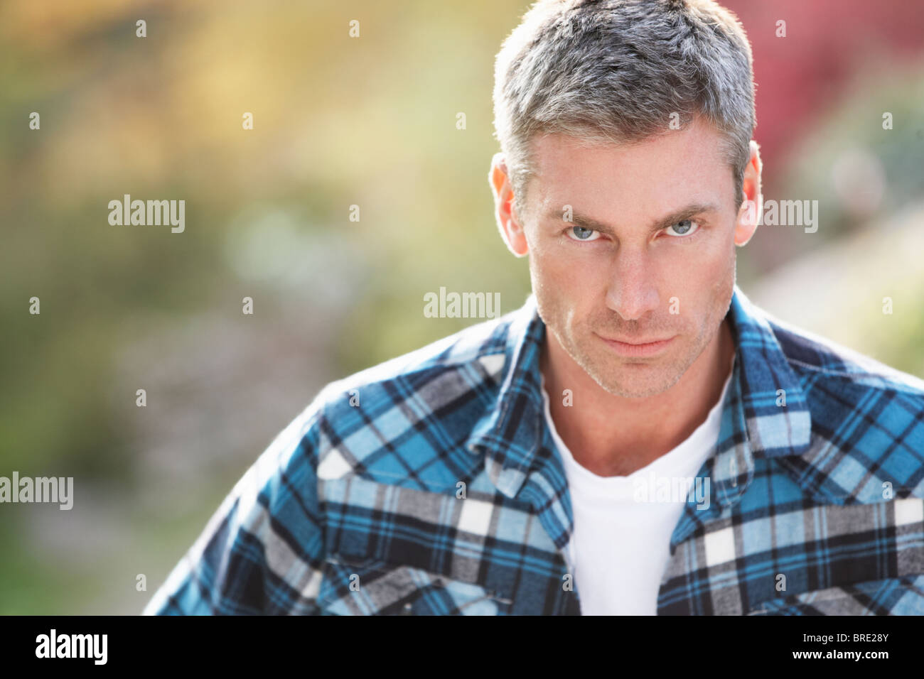 Portrait Of Man Standing Outside In Autumn Landscape Stock Photo - Alamy