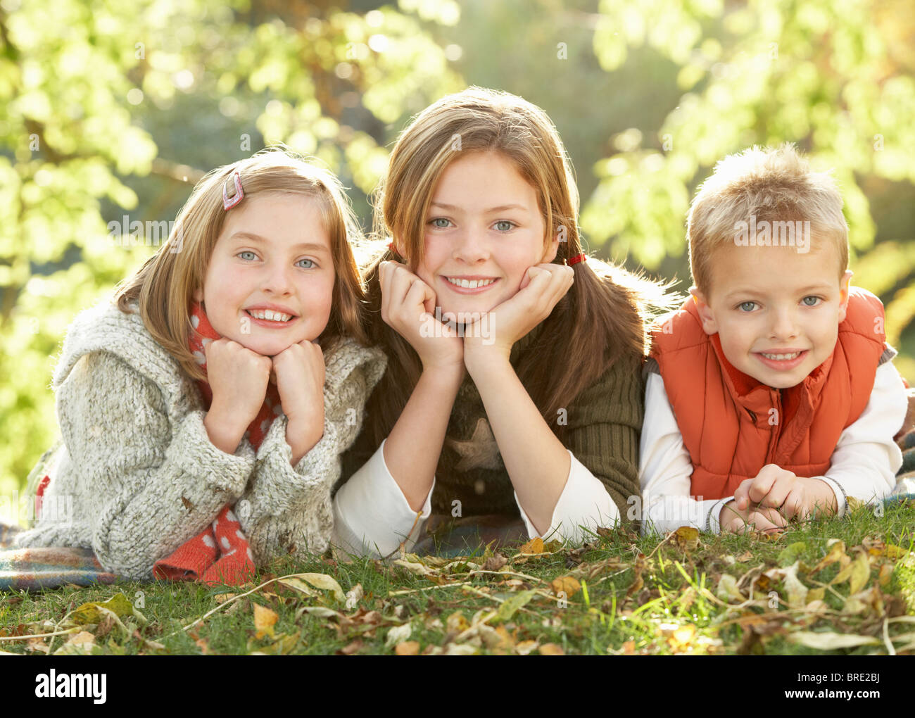 Group Of 3 Children Realxing Outdoors In Autumn Landscape Stock Photo ...