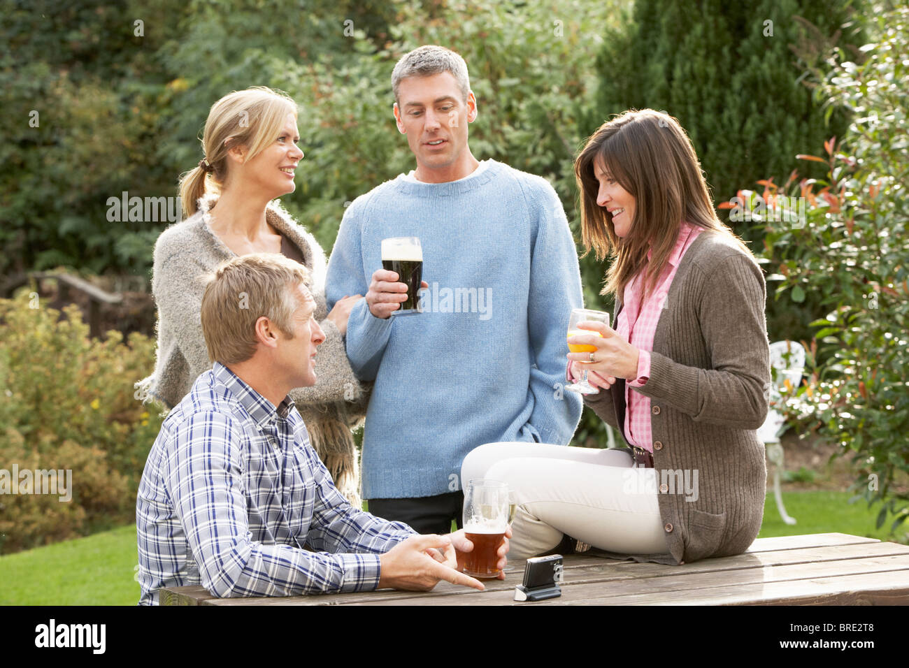Group Of Friends Outdoors Enjoying Drink In Pub Garden Stock Photo - Alamy
