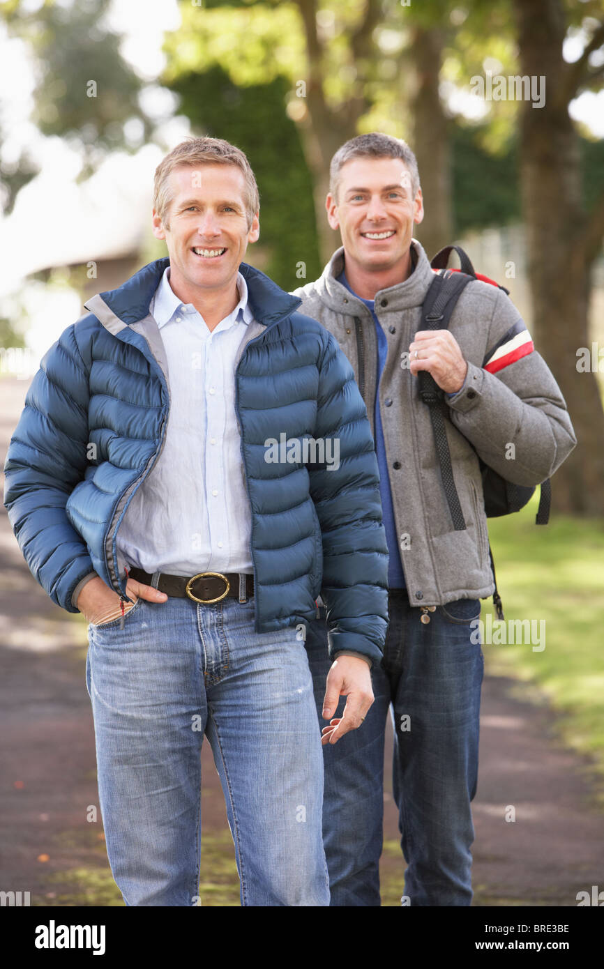 Two male friends walking hi-res stock photography and images - Alamy