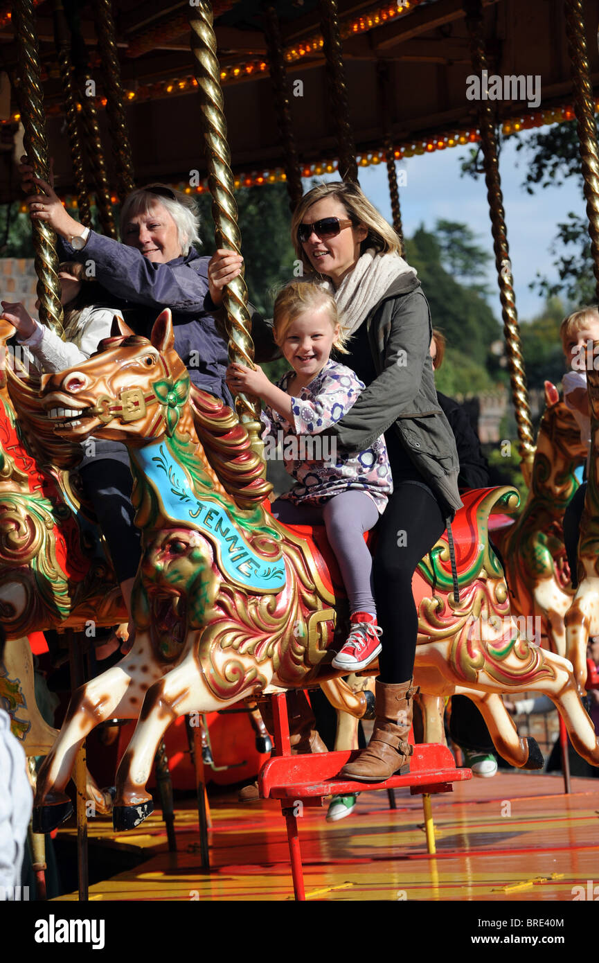 Woman and child riding the carousel Stock Photo - Alamy