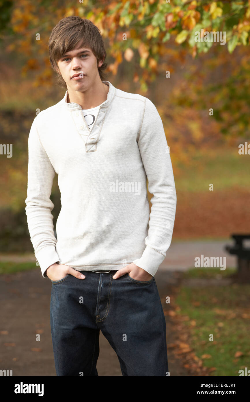 Teenage Boy Standing In Autumn Park Stock Photo - Alamy