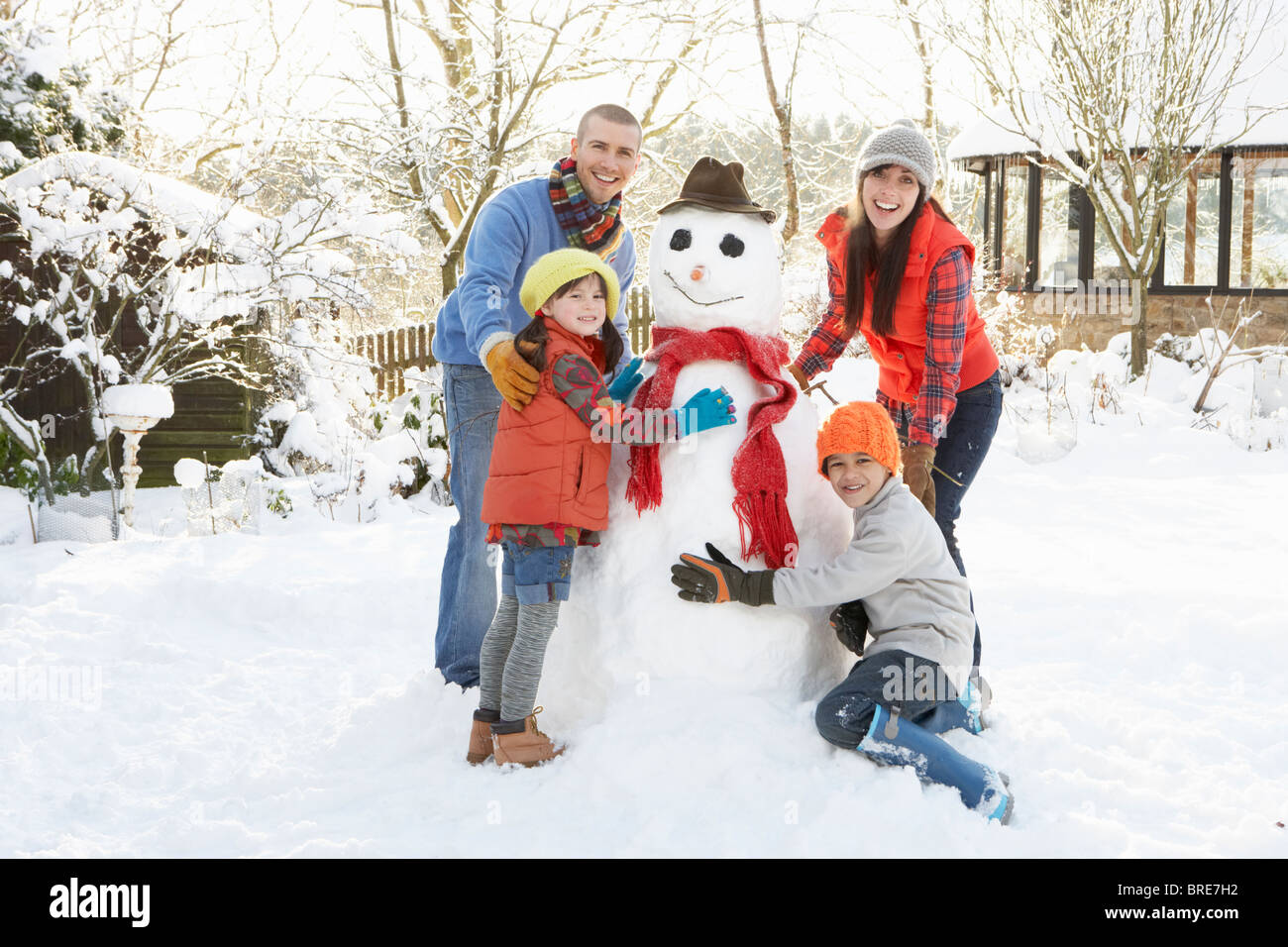 Group young people building snowman hi-res stock photography and images ...