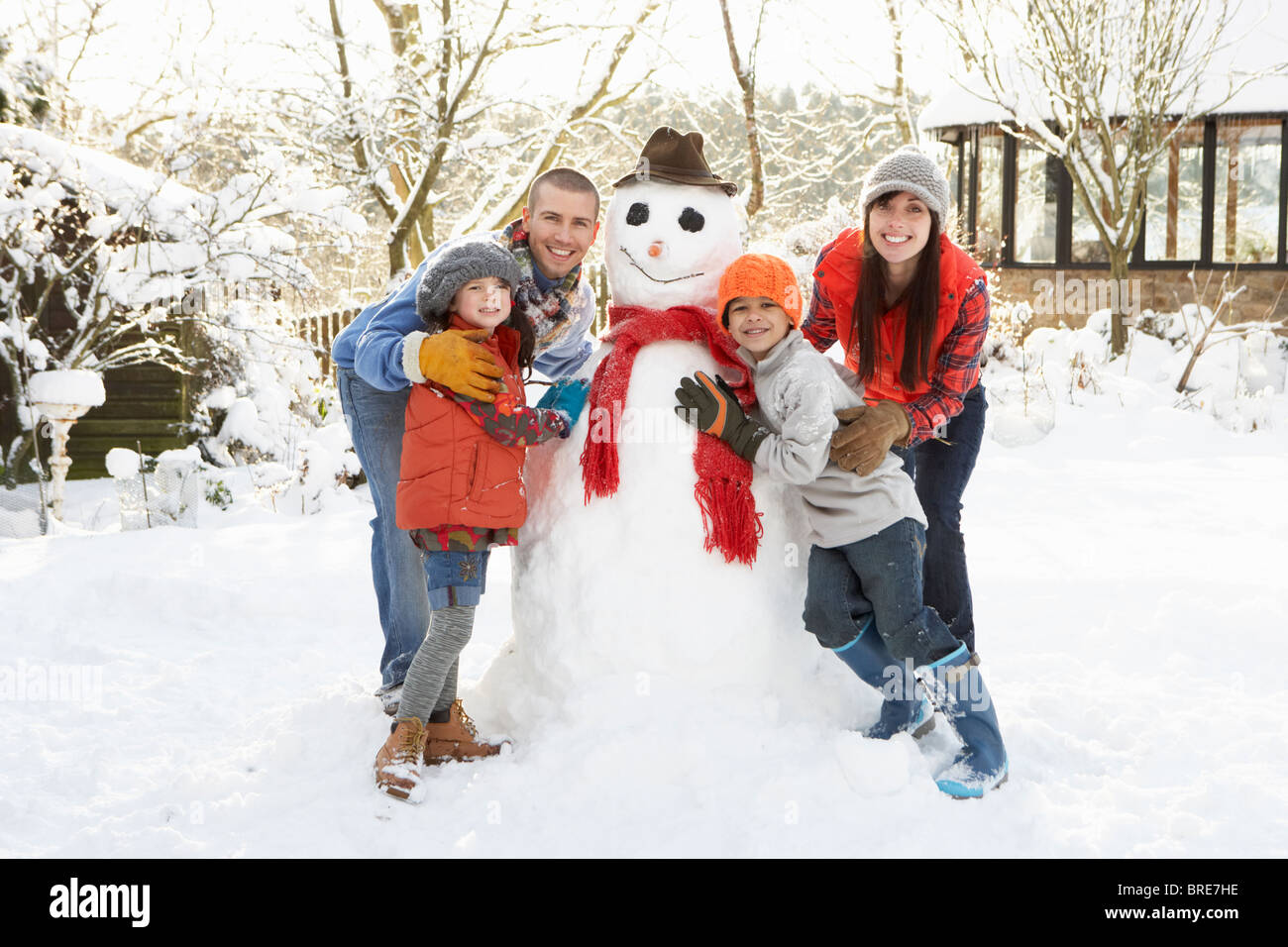 Group young people building snowman hi-res stock photography and images ...