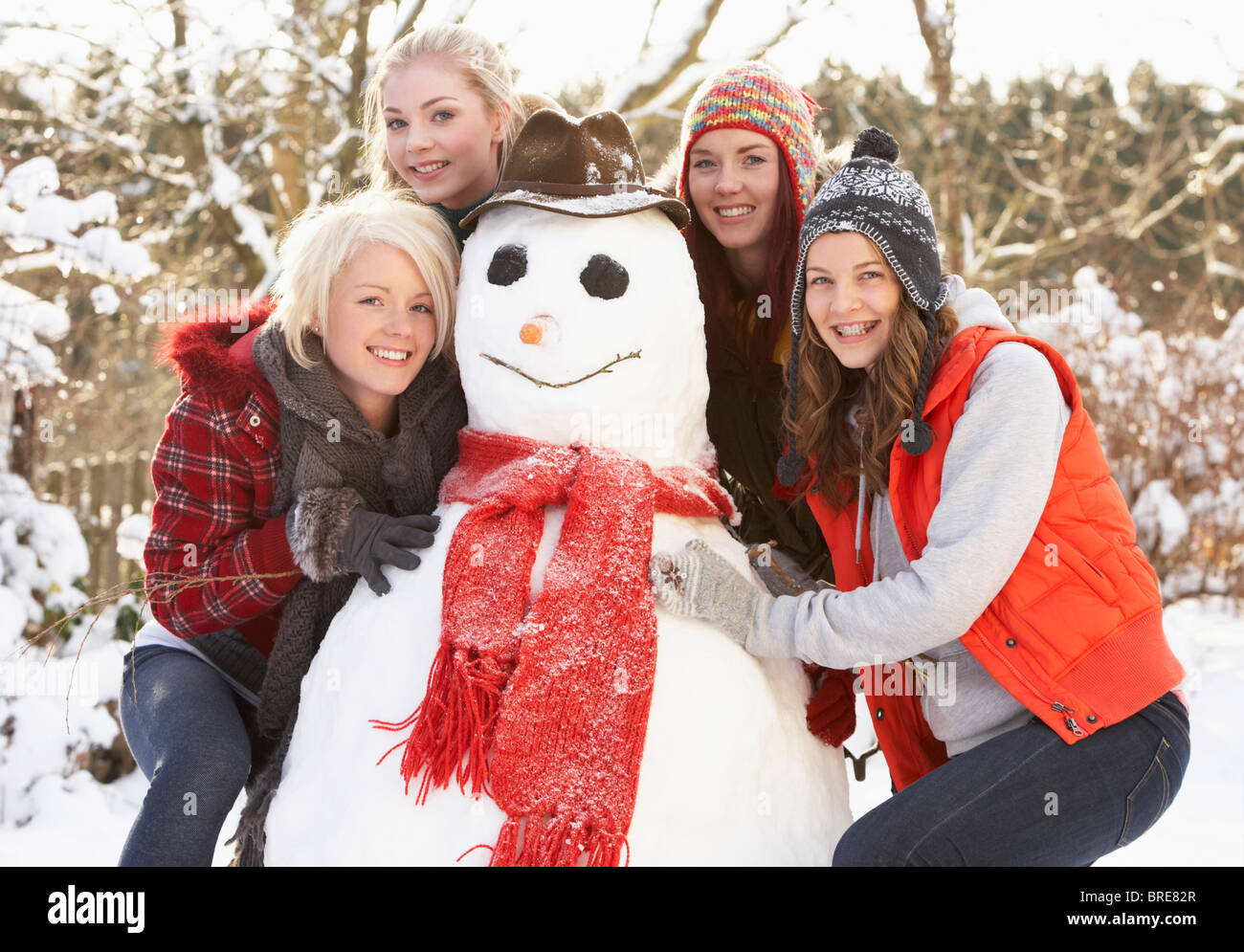 Group young people building snowman hi-res stock photography and images ...
