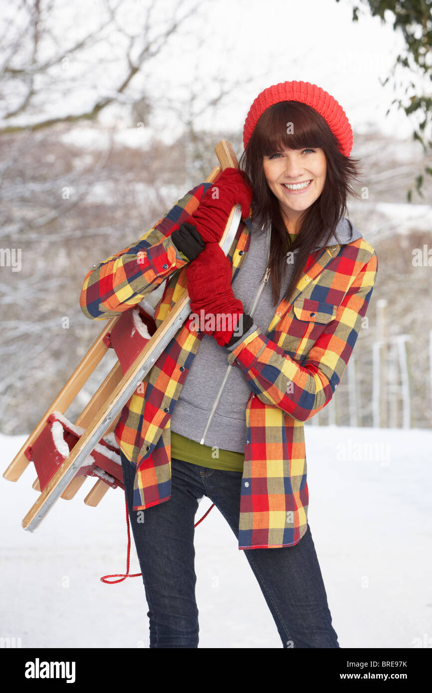 Woman Holding Sledge In Snowy Landscape Stock Photo - Alamy