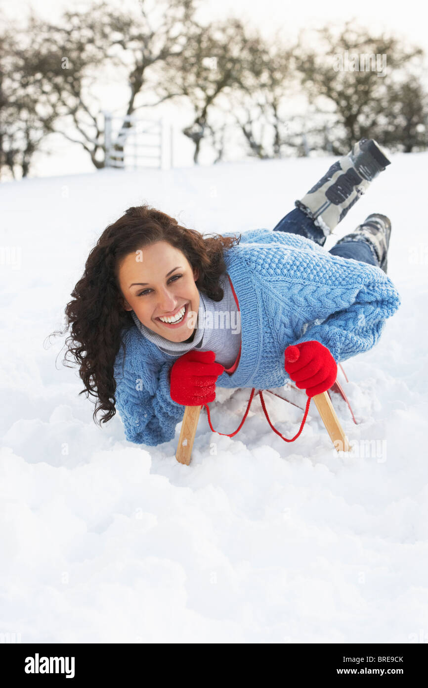 Young Woman Riding On Sledge In Snowy Landscape Stock Photo - Alamy