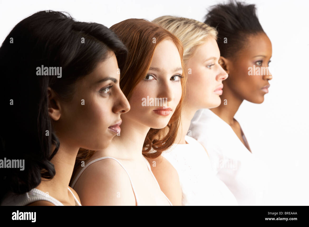 Portrait Of Four Attractive Young Women In Studio Standing In Line ...
