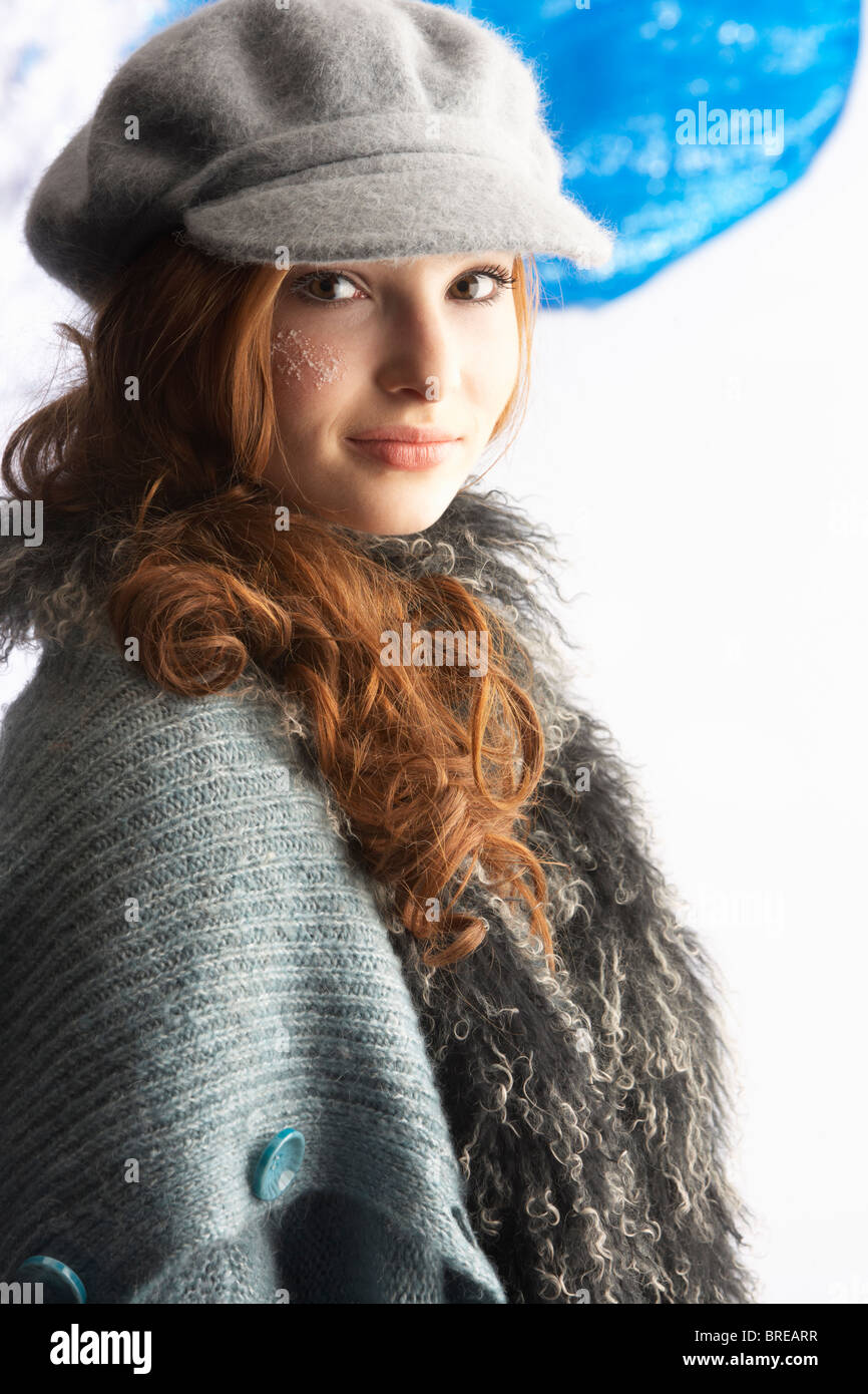 Fashionable Teenage Girl Wearing Cap And Knitwear In Studio Stock Photo ...