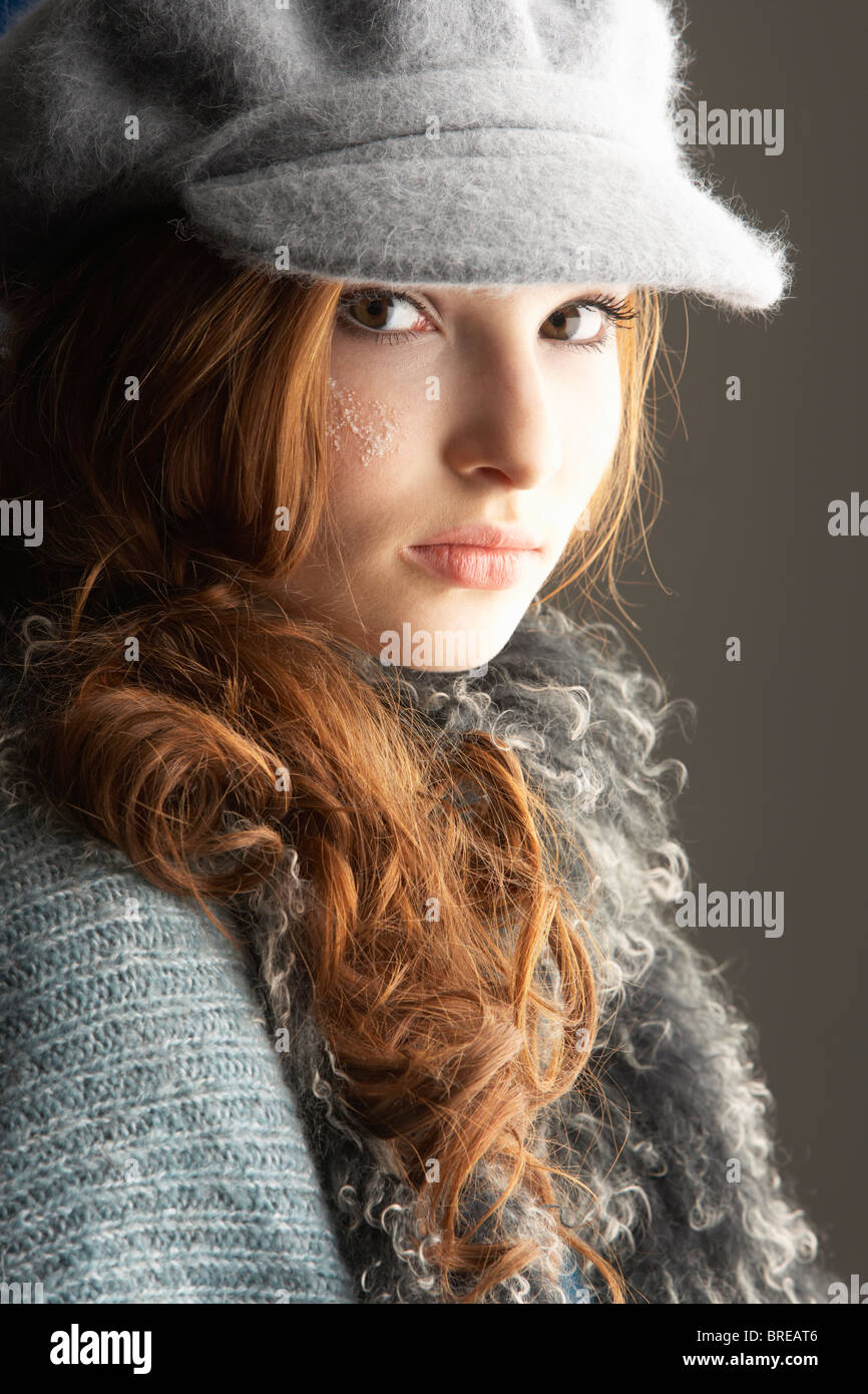 Fashionable Teenage Girl Wearing Cap And Knitwear In Studio Stock Photo ...