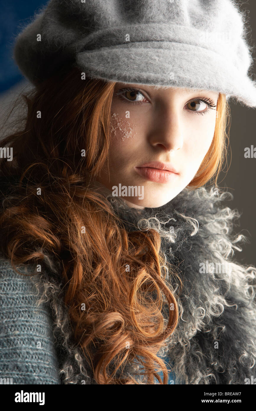 Fashionable Teenage Girl Wearing Cap And Knitwear In Studio Stock Photo ...