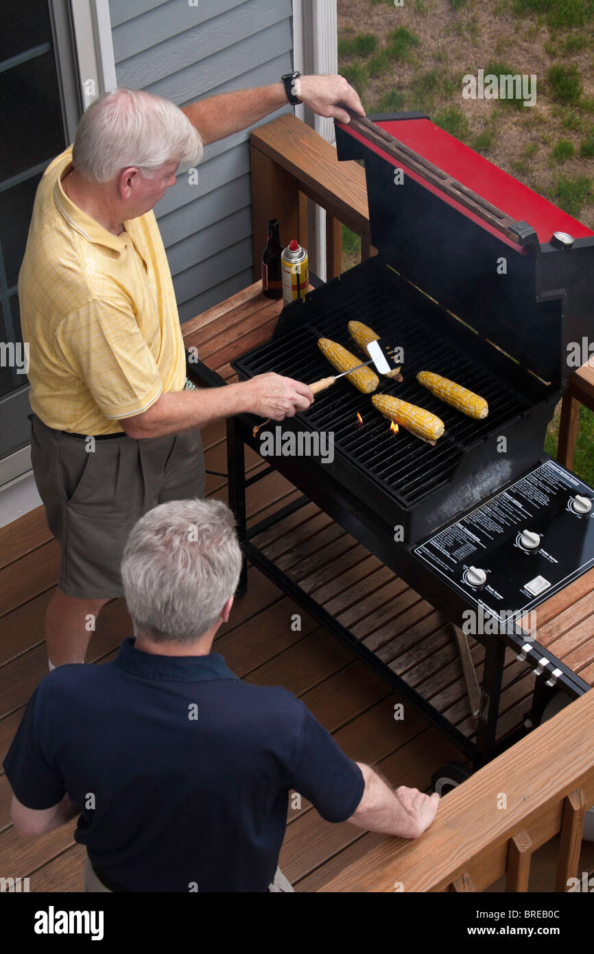 Mature Men Grilling on Backyard Deck Stock Photo - Alamy