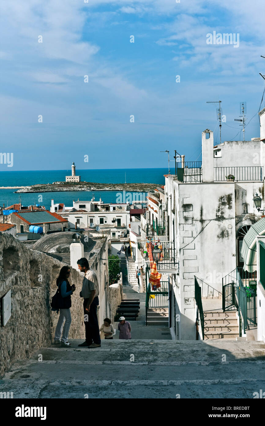 Street of Vieste with the lighthouse on the background, Gargano, Foggia ...