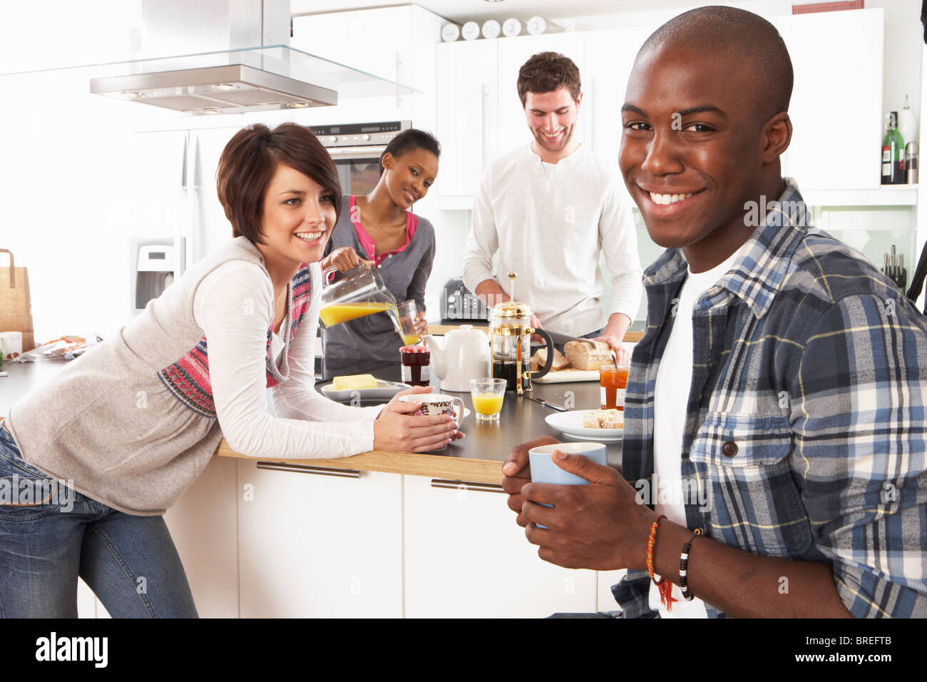 Group Of Young Friends Preparing Breakfast In Modern Kitchen Stock ...