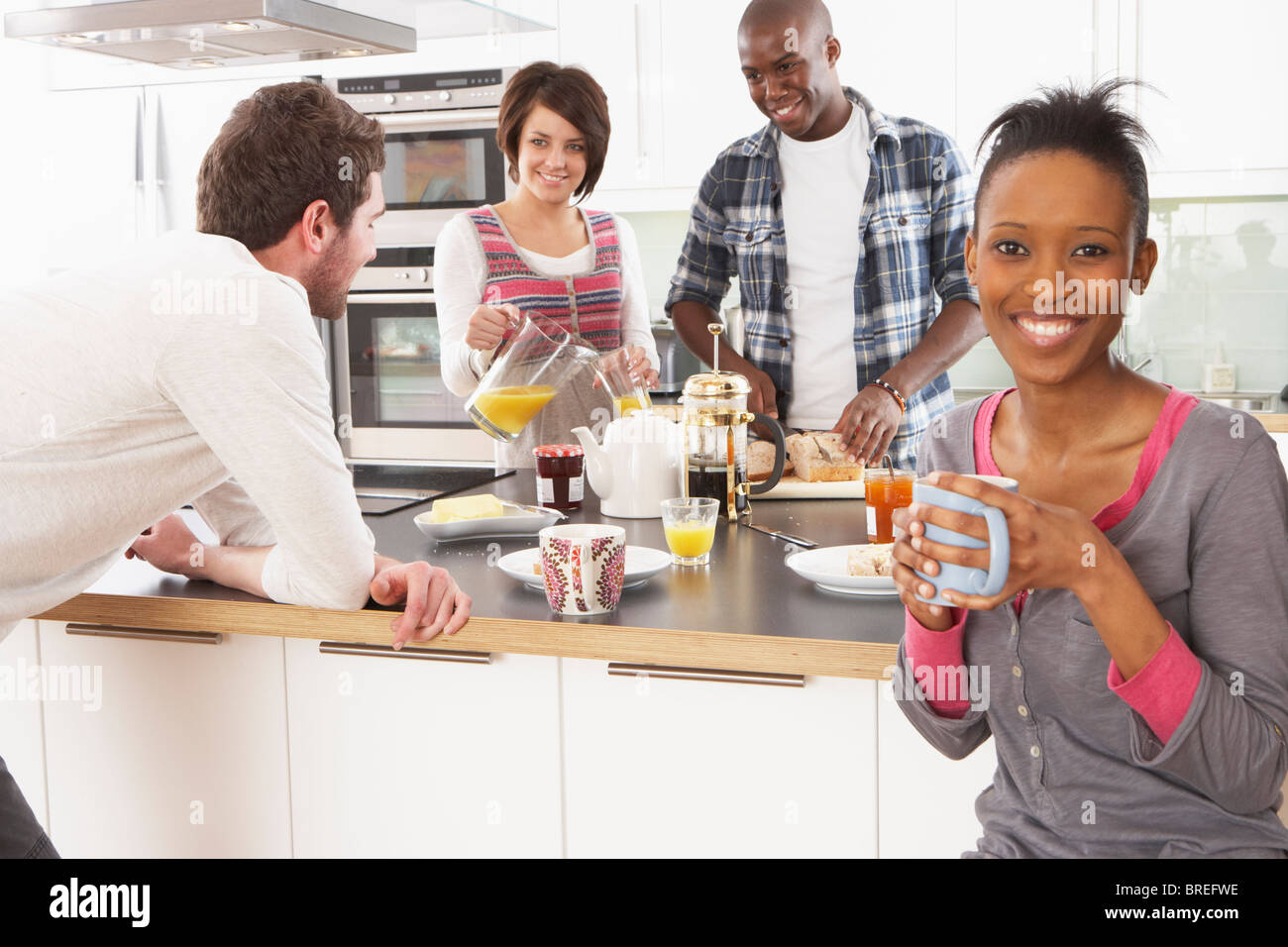 Group Of Young Friends Preparing Breakfast In Modern Kitchen Stock ...